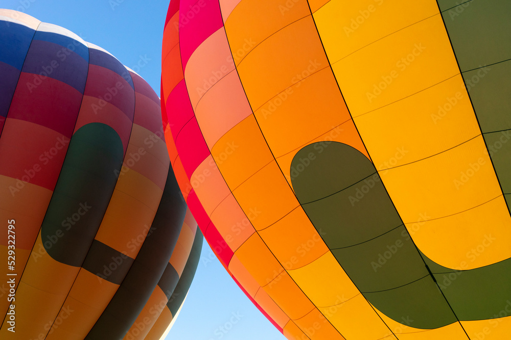 Two hot air balloons take of under a clear blue sky Stock Photo | Adobe ...