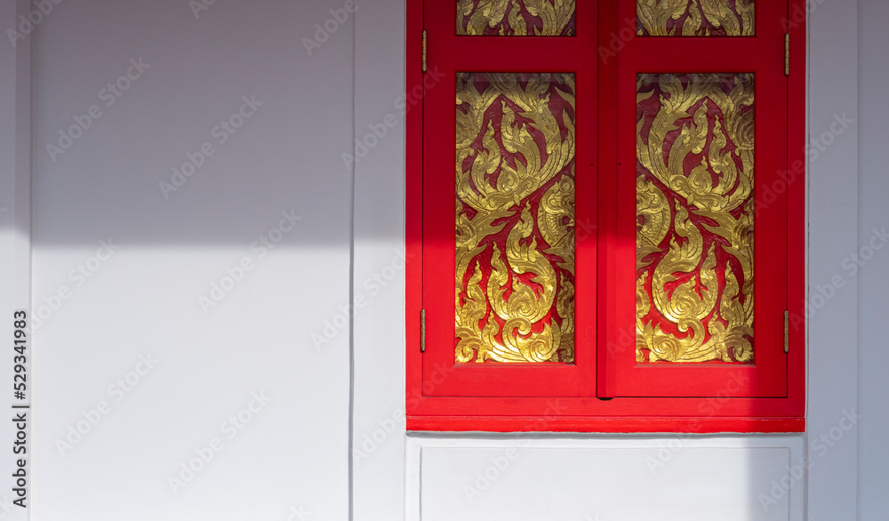 Sunlight and shadow on surface of red wooden window with golden ...