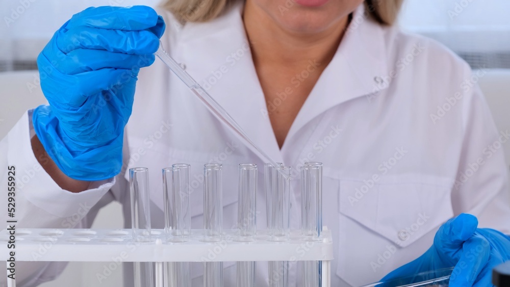 professional scientist takes a sample for a medical experiment. A ...