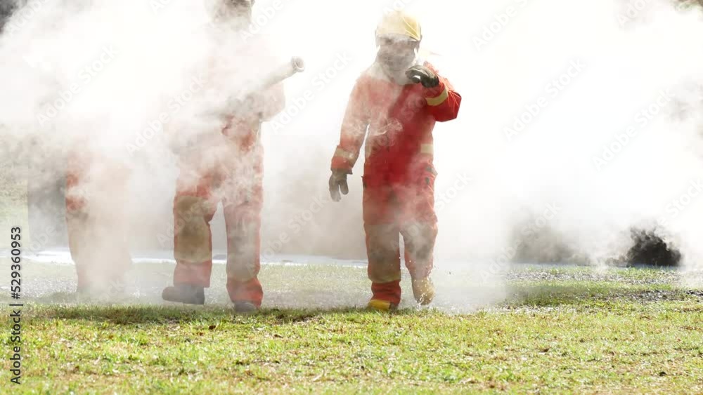 Firefighter fighting with fire flame protection property. Fireman wear ...