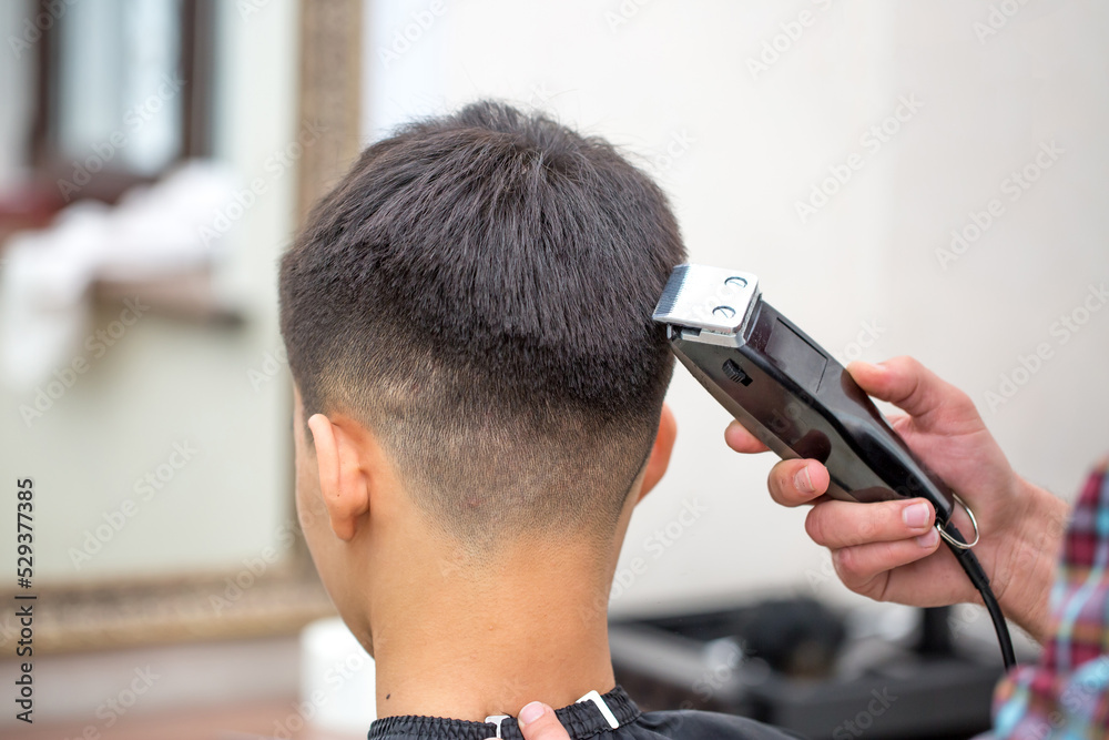 Male hairdresser, grooming men. Haircut styler and trimmer. The master ...