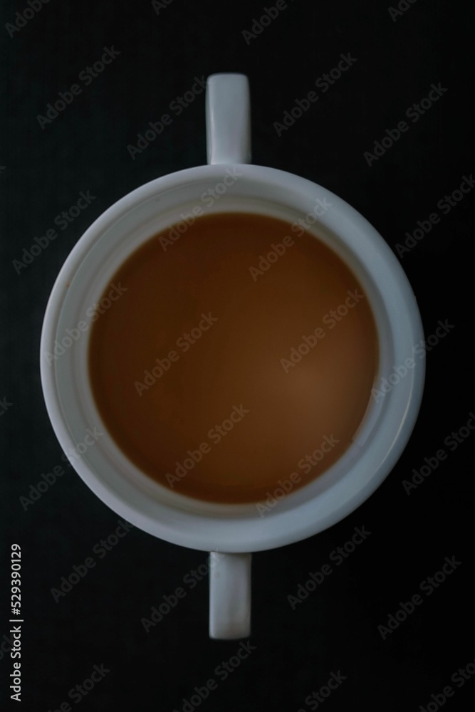 Top view of a coffee mug on a black background. Stock Photo | Adobe Stock