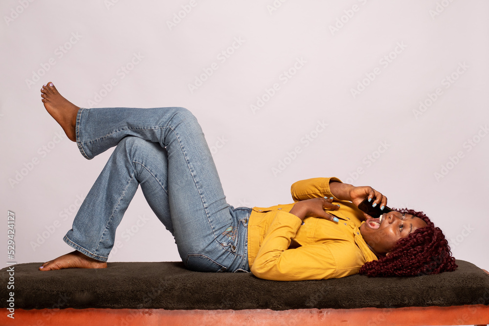 young black woman making a phone call looks amazed Stock Photo | Adobe ...