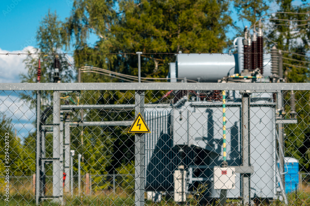Poster High voltage electrical substation behind metal mesh fence ...