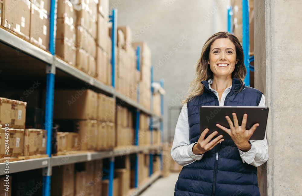 Happy warehouse manager smiling at the camera Stock Photo | Adobe Stock