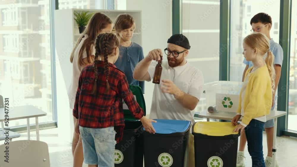 Garbage recycling children. Male teacher shows to the pupils how and ...
