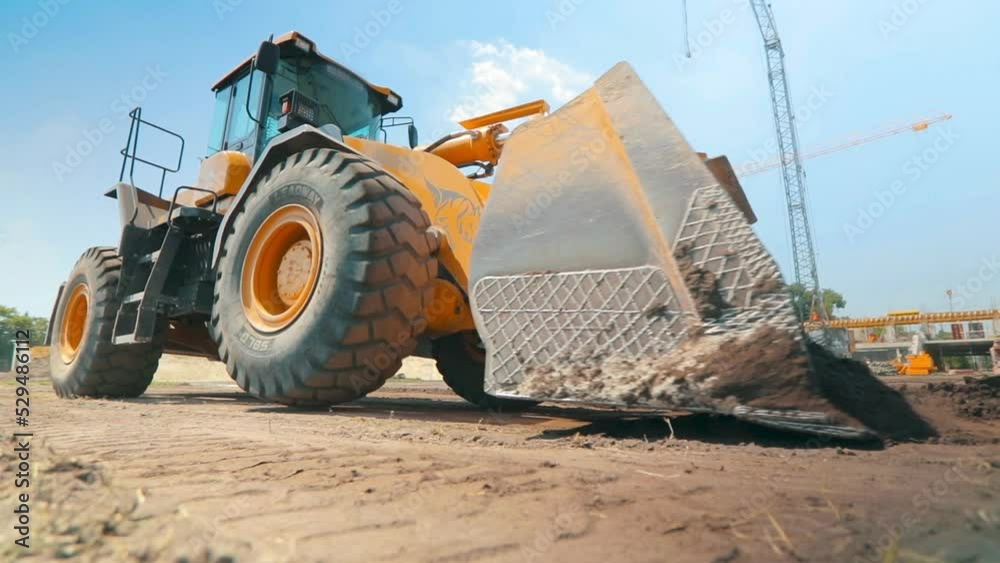 Yellow tractor on a construction site. Professional construction ...