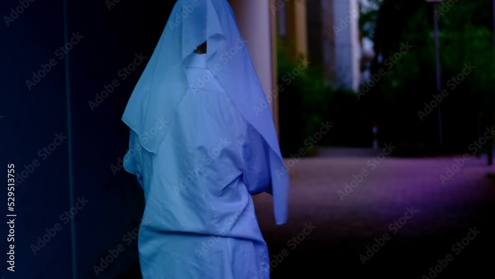 ghost child 10 years old in white hoodie holds pumpkin candle in hands ...