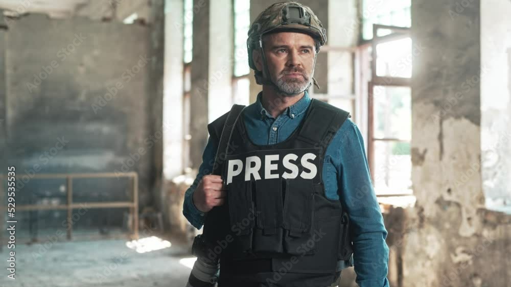 Camera approaching male war press correspondent with photo camera ...