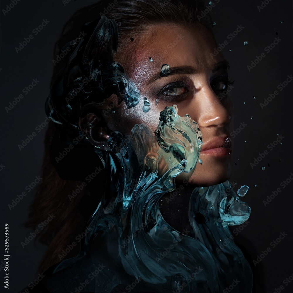 dark femme fatale with gothic makeup is surrounded by splashes of water ...
