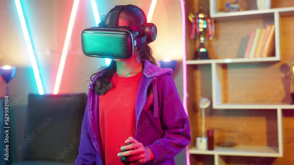 Young teenager girl playing video game on virtural reality or VR ...