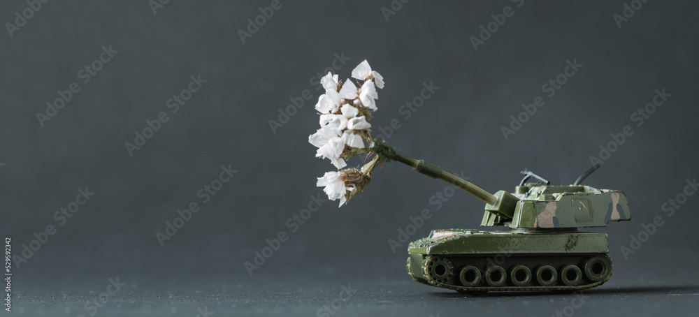 Model toy of battle tank firing flowers from the barrel. Peace and no ...