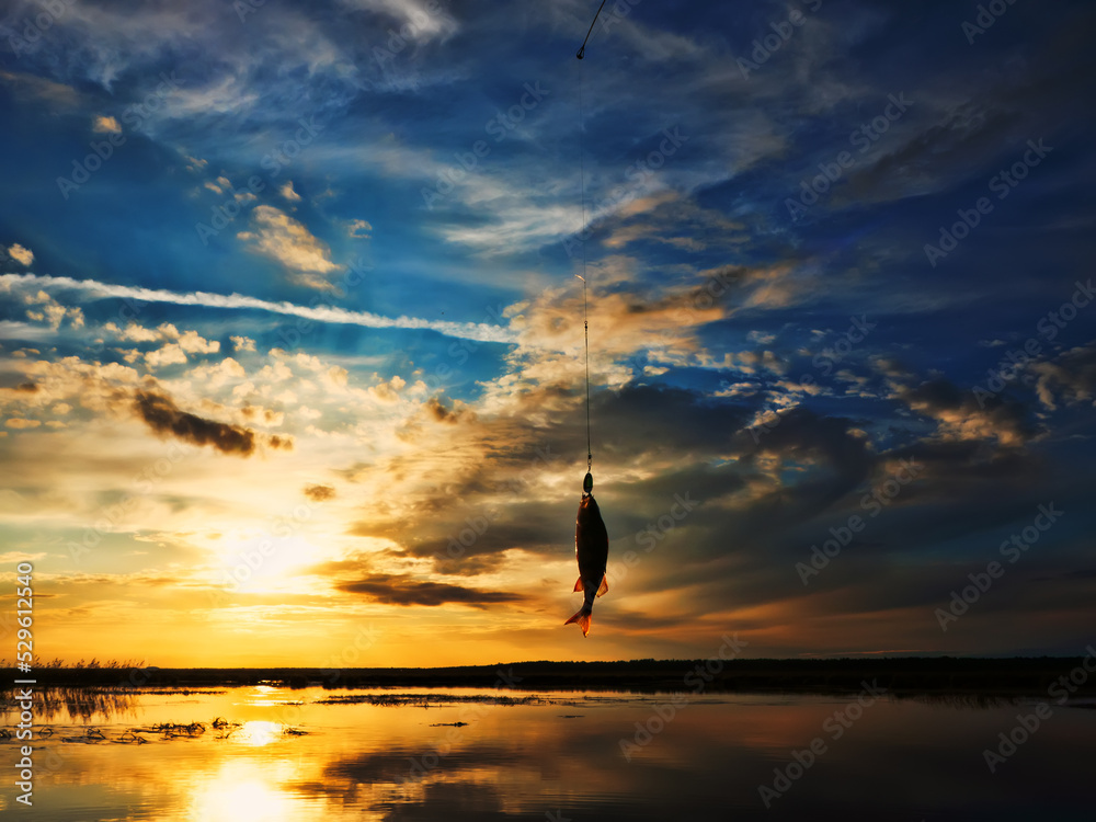 Fishing at sunset. Catching predatory fish on spinning. Sunset colors ...