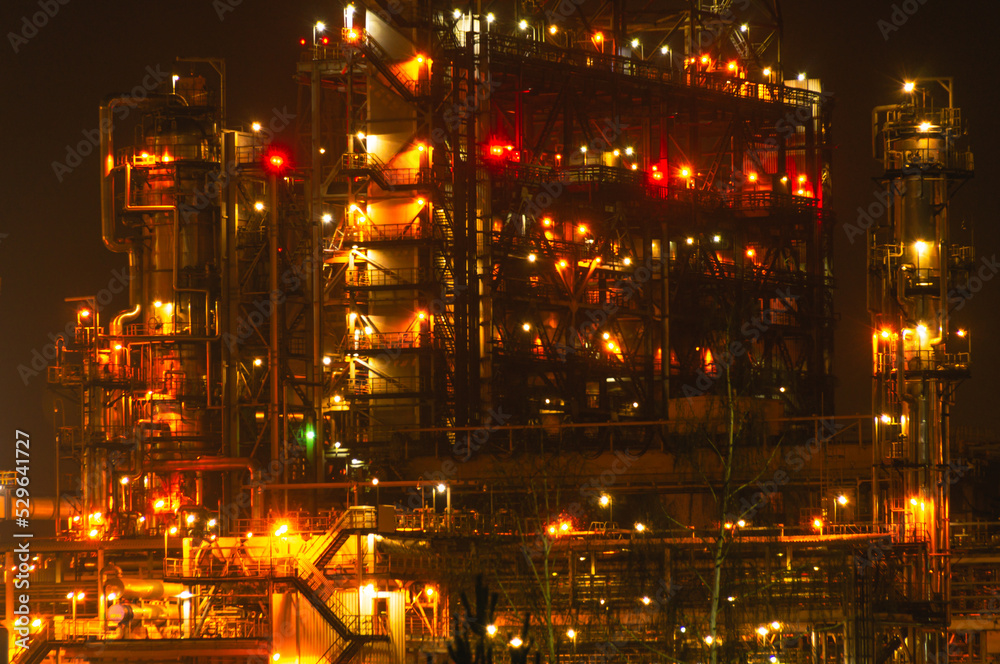 Technological installation at an oil refinery. Lighting of factory ...