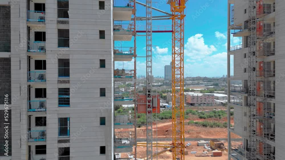 Freight elevator at the construction site of high rides up and down. A ...