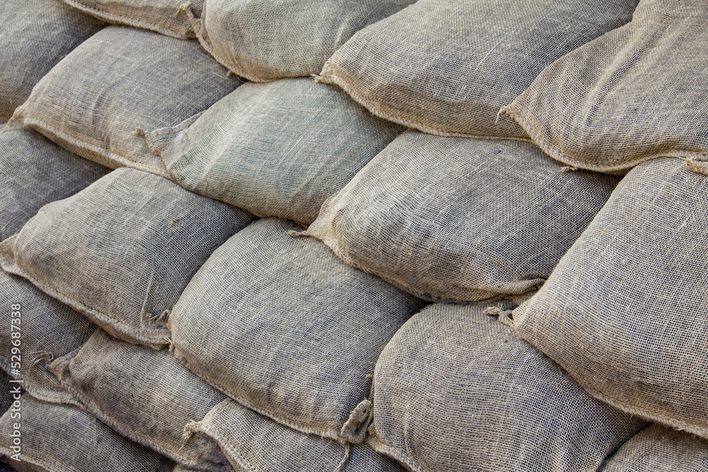Sandbag flood protection barricade wall Background texture. Stock Photo ...