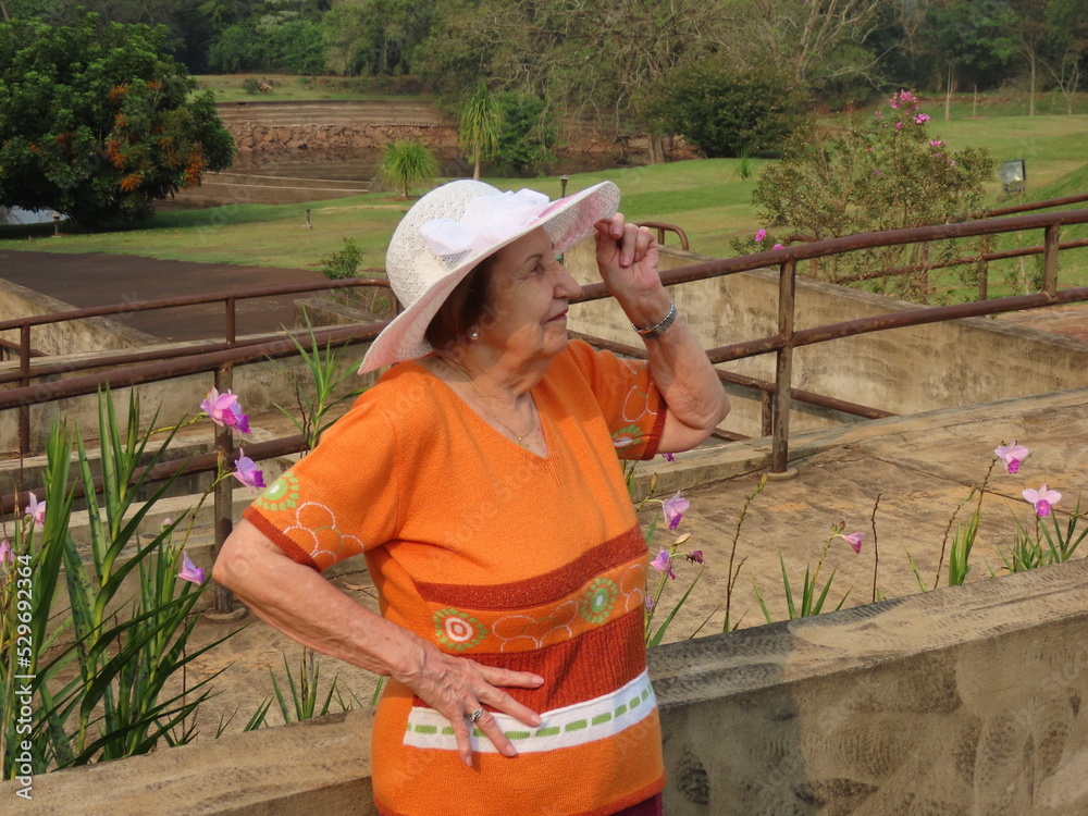 Olg woman in the garden Stock Photo | Adobe Stock