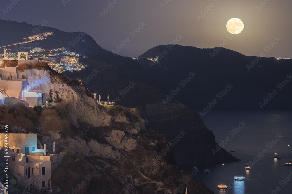 Dramatic full harvest moon rise over the caldera and Greek Island of ...