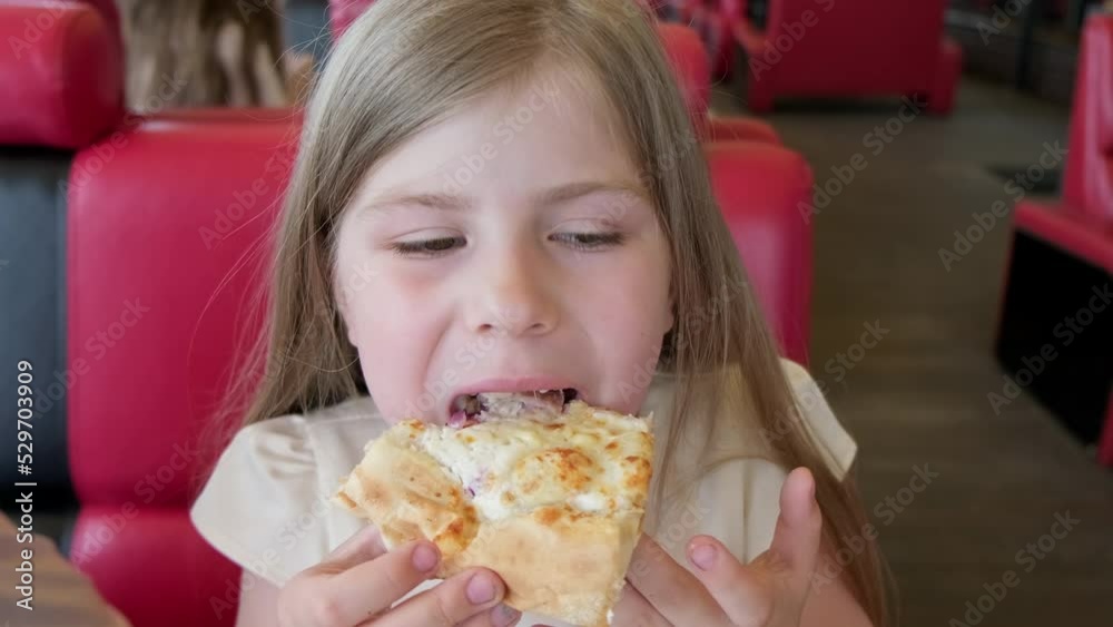 Girl in fast food cafe eating pizza. Unhealthy fast food. Hungry child ...