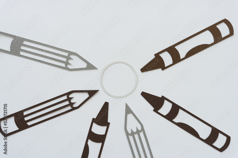 writing instruments (pencil and crayon) silhouettes pointing at a ring ...