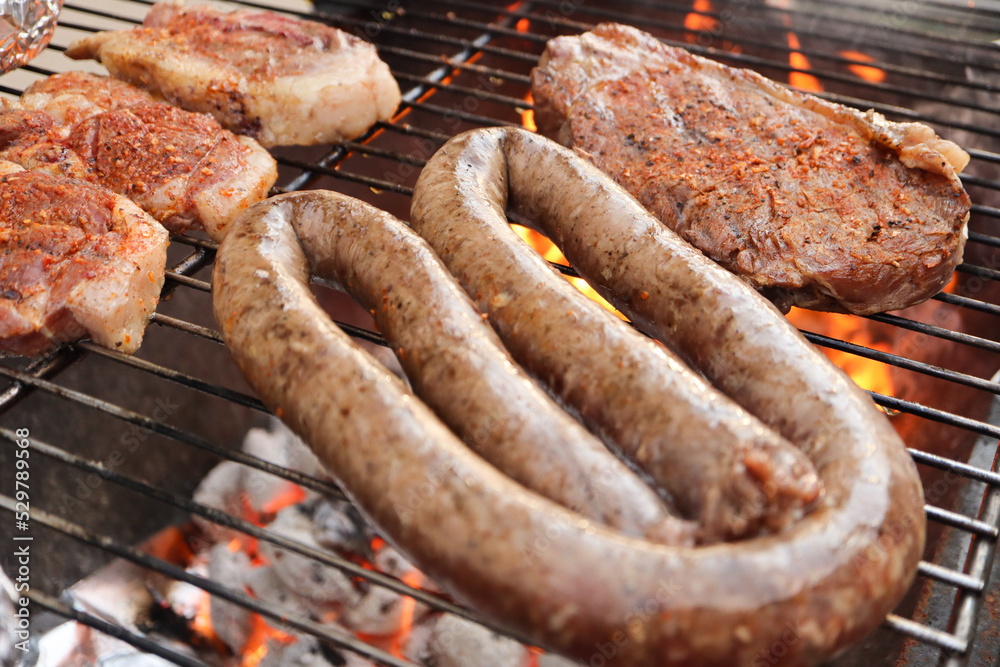 South African braai with meat on the grill. Boerewors sausage, lamb ...