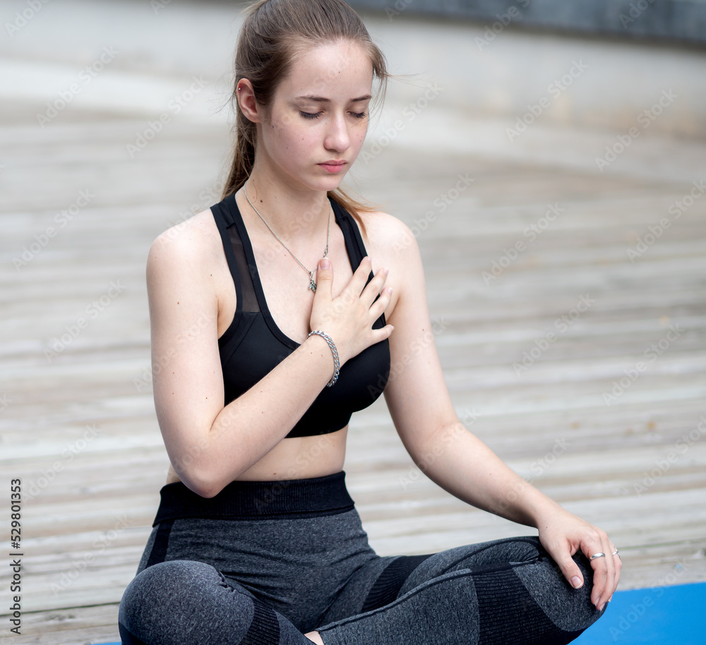 Woman practices yoga namaste position opening soul heart chakra at ...