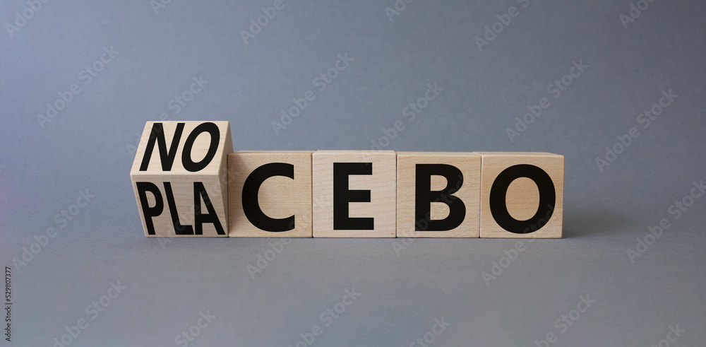 Nocebo vs Placebo symbol. Turned wooden cubes with words Placebo and ...