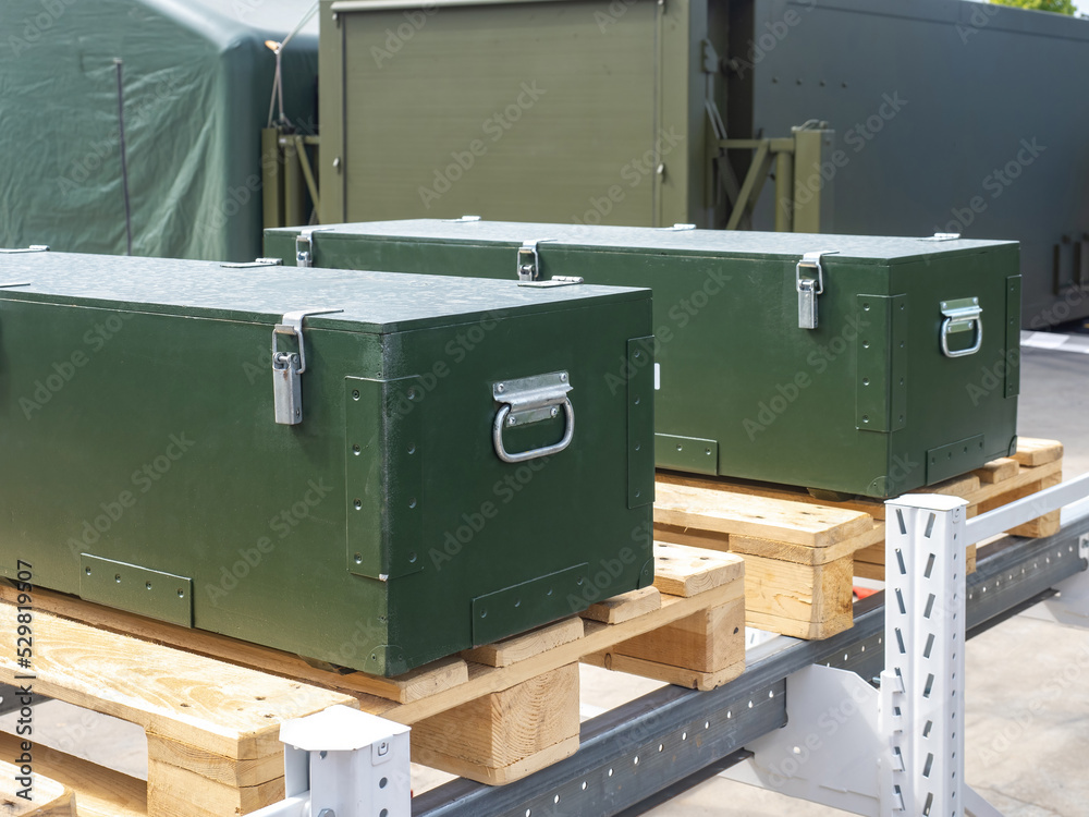 Green boxes on pallets. Long coffers for industrial equipment. Box for ...