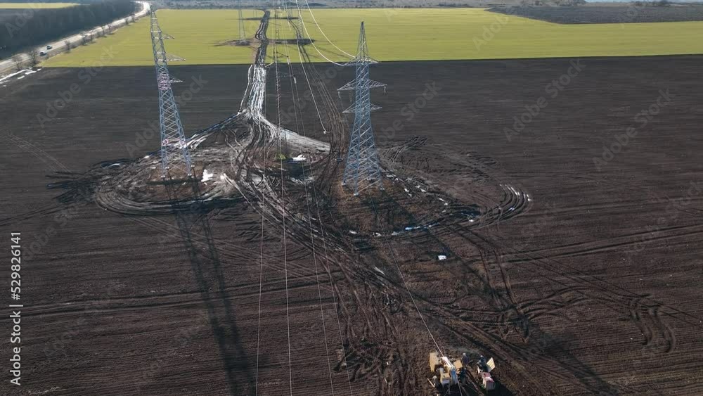 Aerial circling view of steel erector workers strengthen a newly ...
