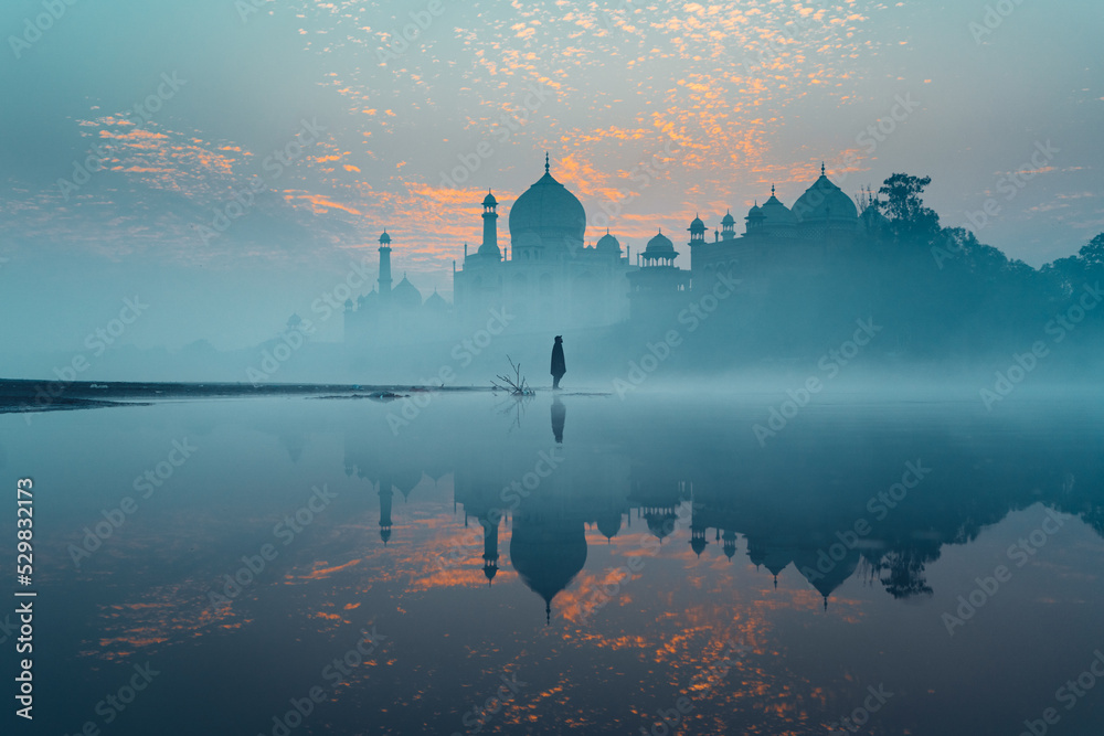 Taj mahal reflection view from back side on a winter morning, foggy and ...