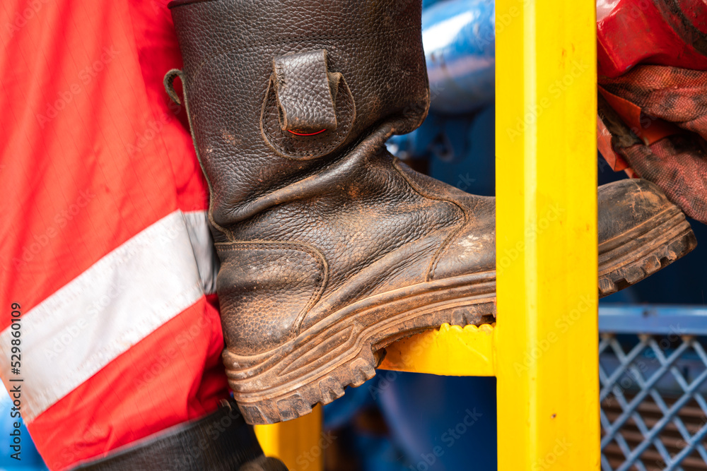 Action of a construction worker is climbing on the platform ladder. An ...