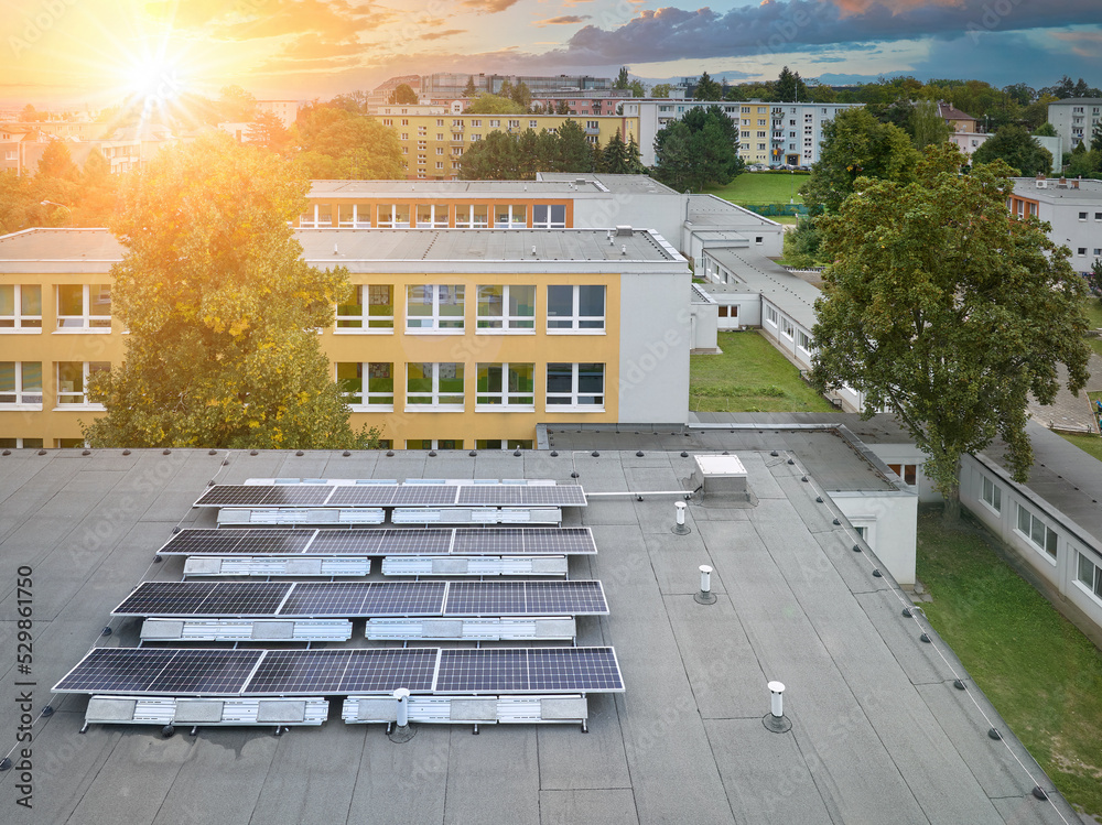 Solar power plant on the school roof. View of the photovoltaic panels ...