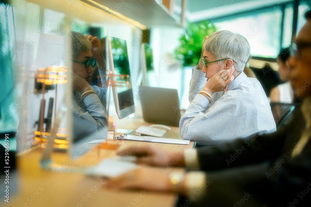 Businesswoman looking at a computer monitor during his working day in ...