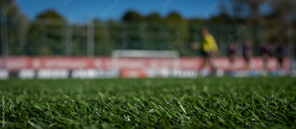 Football background with green grass space for copy and out of focus ...