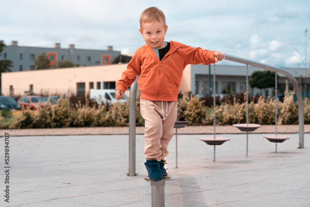 Children playing on playground. Kid balancing concept. Boy keeps ...