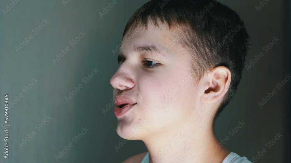 Close-up of a Face Profile of Talking Smiling Teenager Looking Down ...