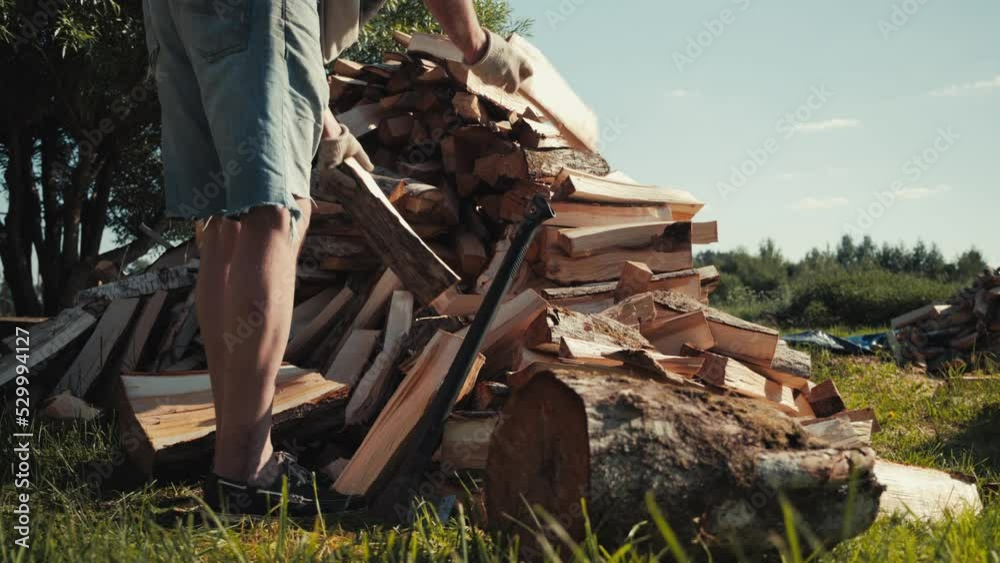 Slow motion of strong male worker chopping wood in backyard outdoors ...