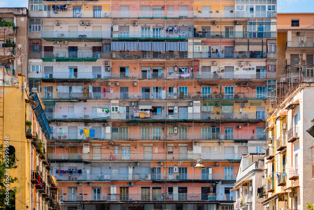 Colorful facade of a big block of flats in the old town “Centro storico ...