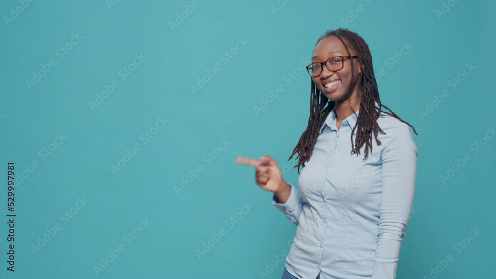 Portrait of young adult indicating at left and right sides, showing ...