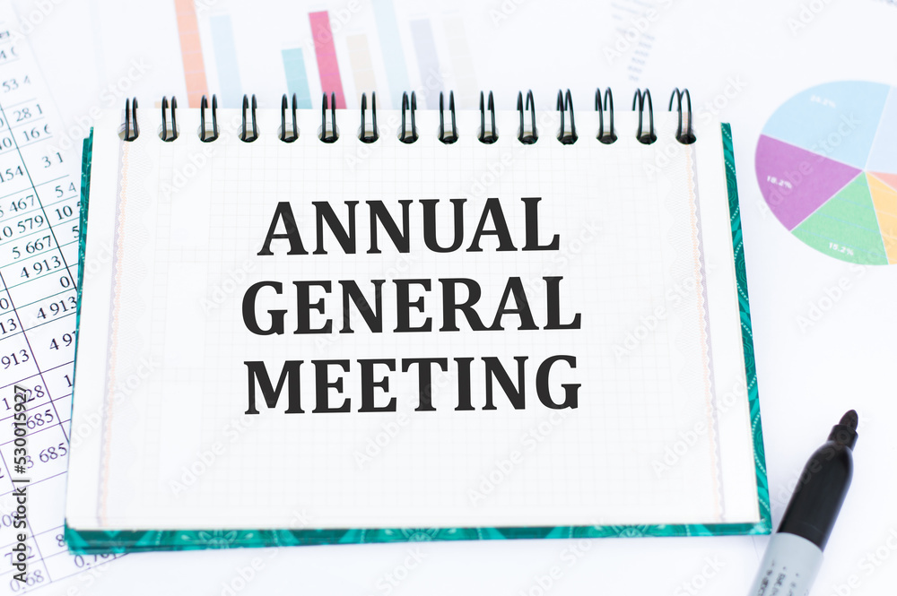 AGM Annual General Meeting is written in red on a white piece of paper ...