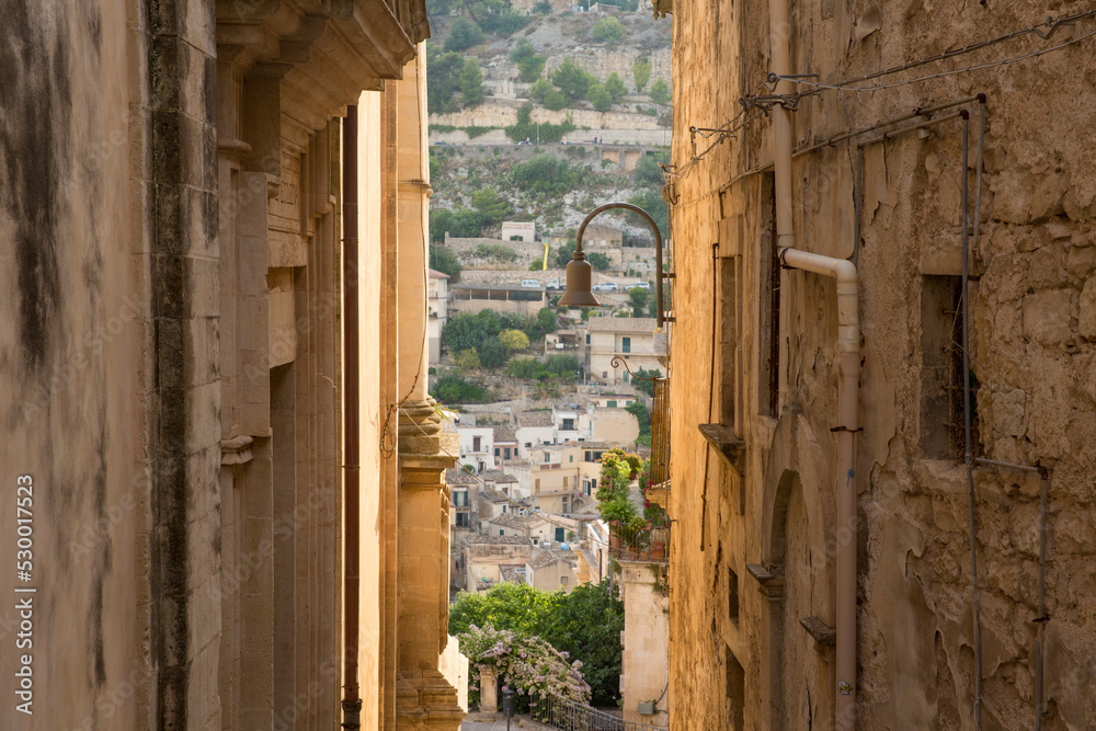 An alley between two buildings in which it is seen panoramic view of ...