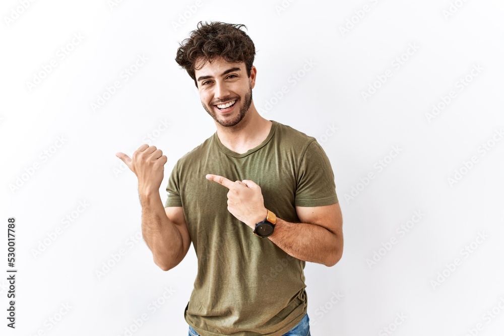 Hispanic man standing over isolated white background pointing to the ...