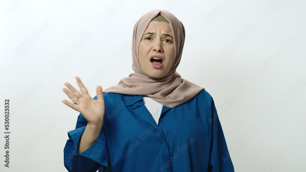 The headscarved woman is very angry at what happened. She shouts ...