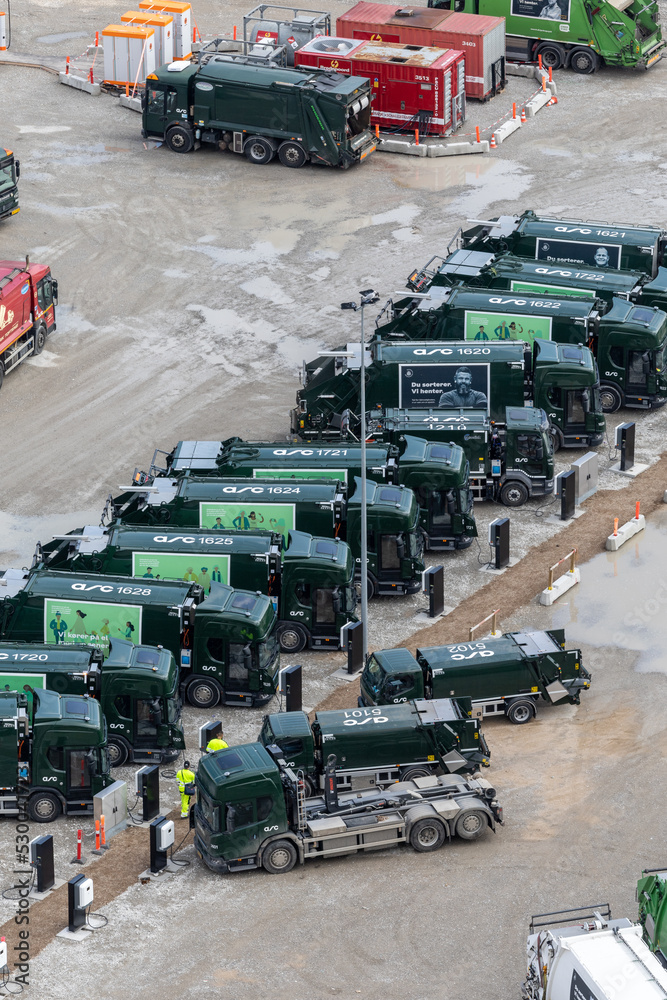 Copenhagen, Denmark A row of garbage trucks parked below the Amager ...