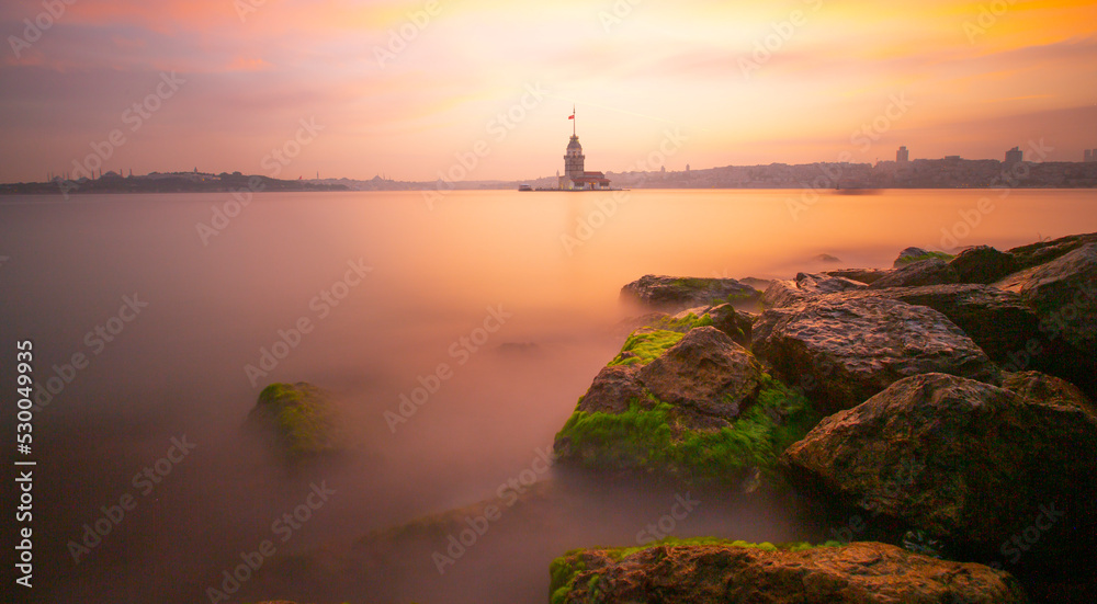 Fiery sunset over Bosphorus with famous Maiden's Tower (Kiz Kulesi ...