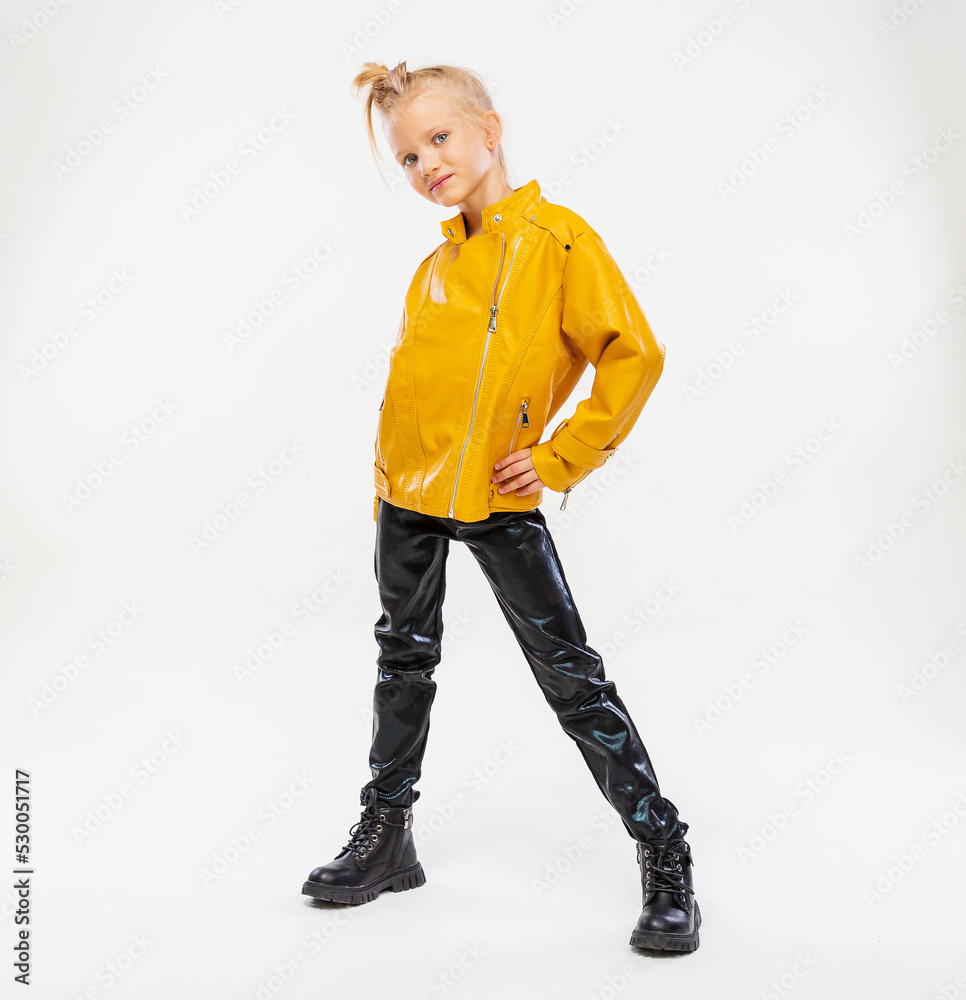 Pretty blonde little girl in a leather mustard jacket, black snake ...