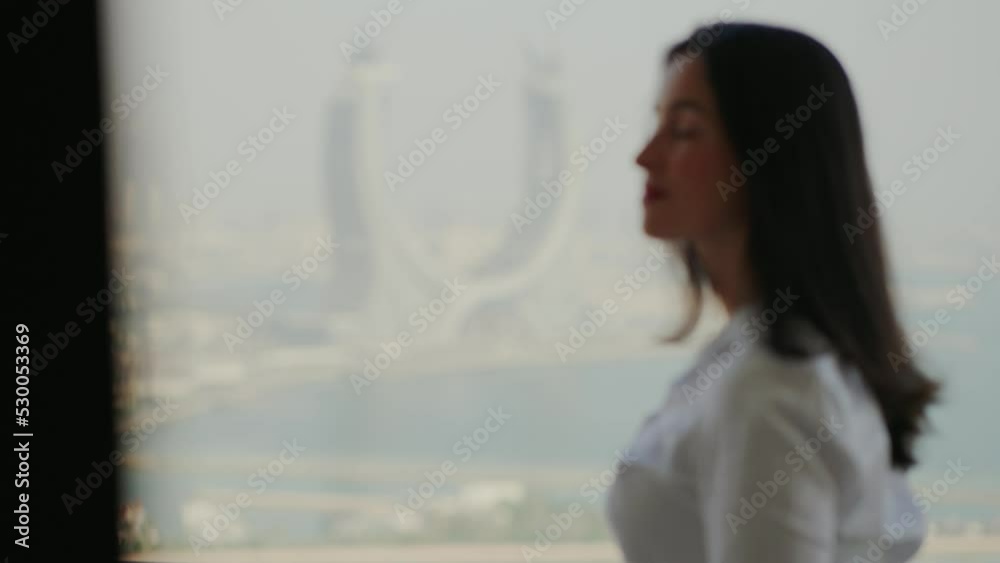 Tourist at hotel balcony showing Lusail crescent moon building at Doha ...