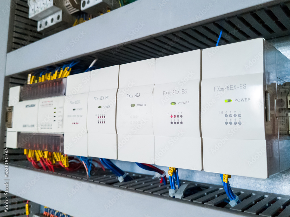 Mitsubishi PLC modules in a row in electrical cabinet of automation ... Mitsubishi PLC modules in a row in electrical cabinet of automation ...