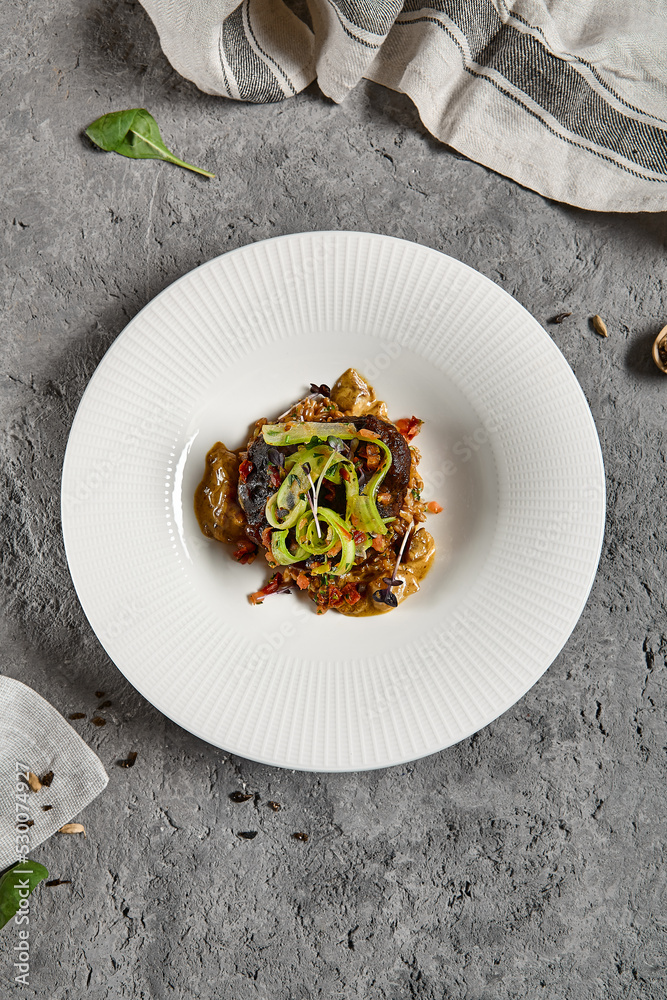 Braised beef cheeks with pearl barley and celery in creamy mushroom ...