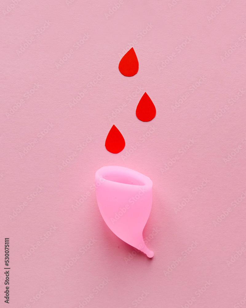 Menstrual cup and drops of blood on a pink background Stock Photo ...